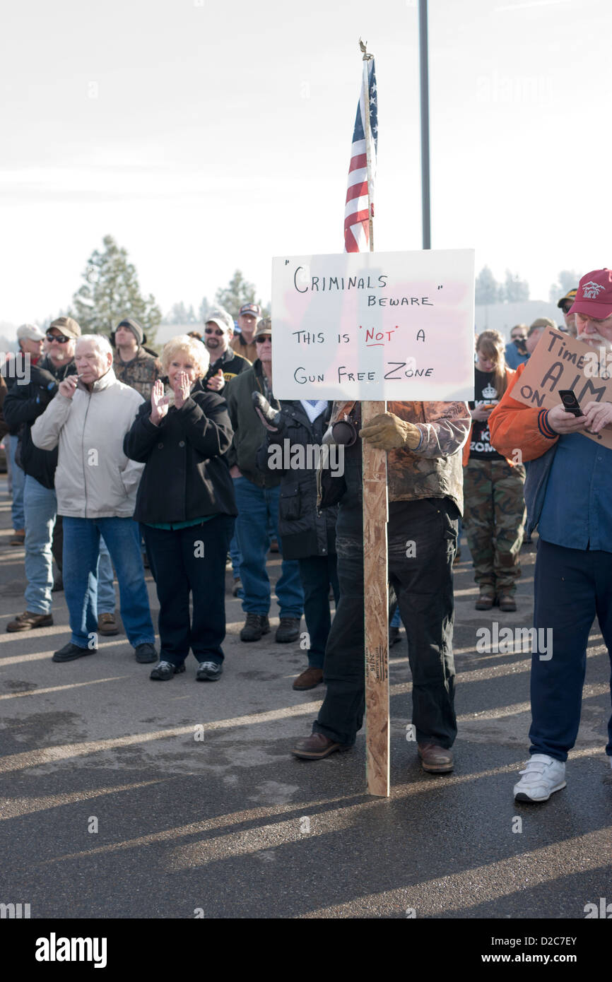 Man holds sign at rally Stock Photo - Alamy