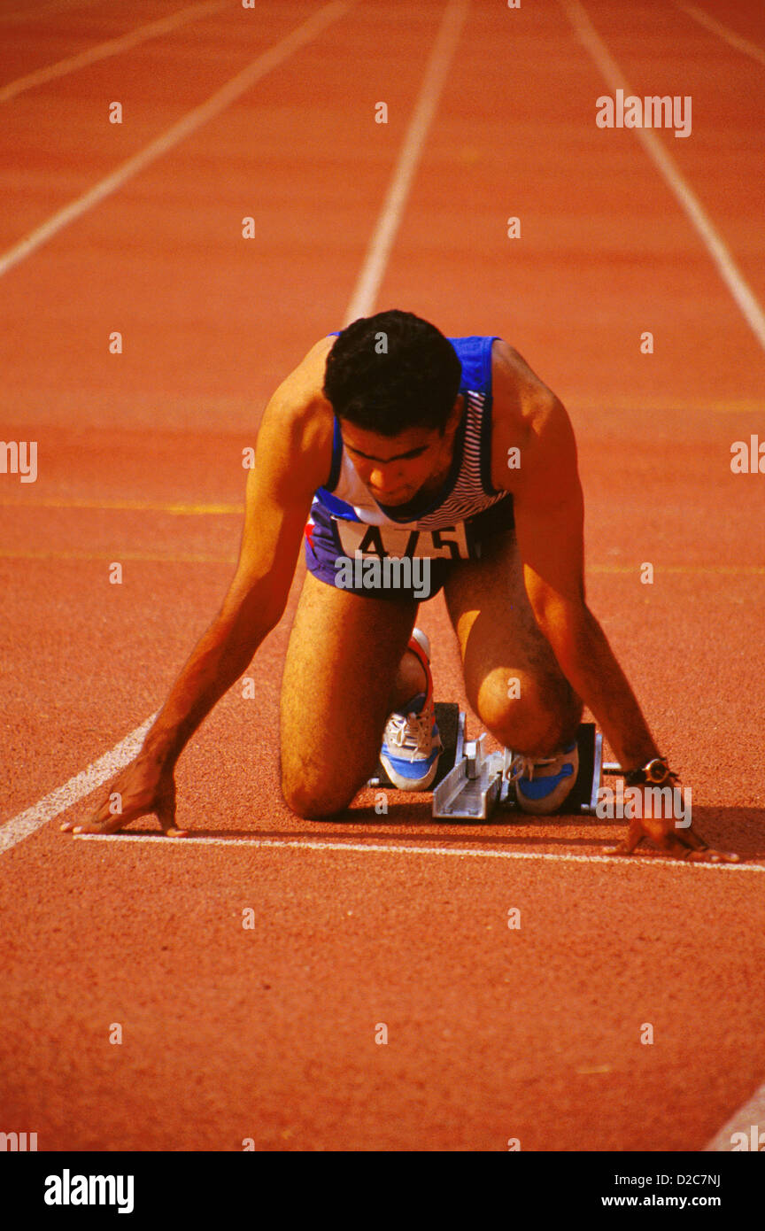 Runner At Starting Line Stock Photo - Alamy