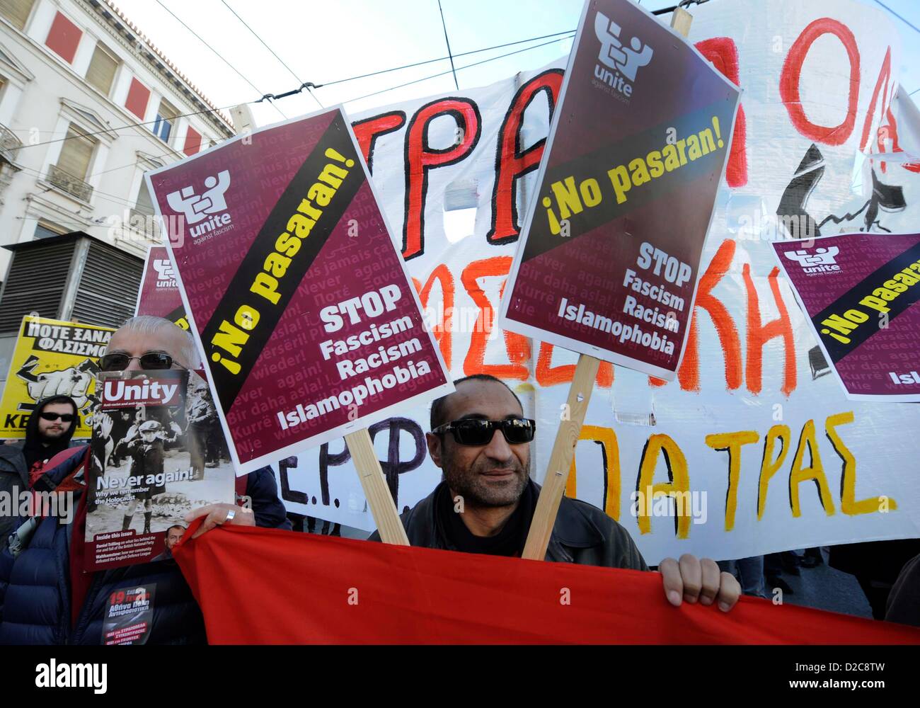 Protesters shout slogans and hold placards during an anti-fascist ...