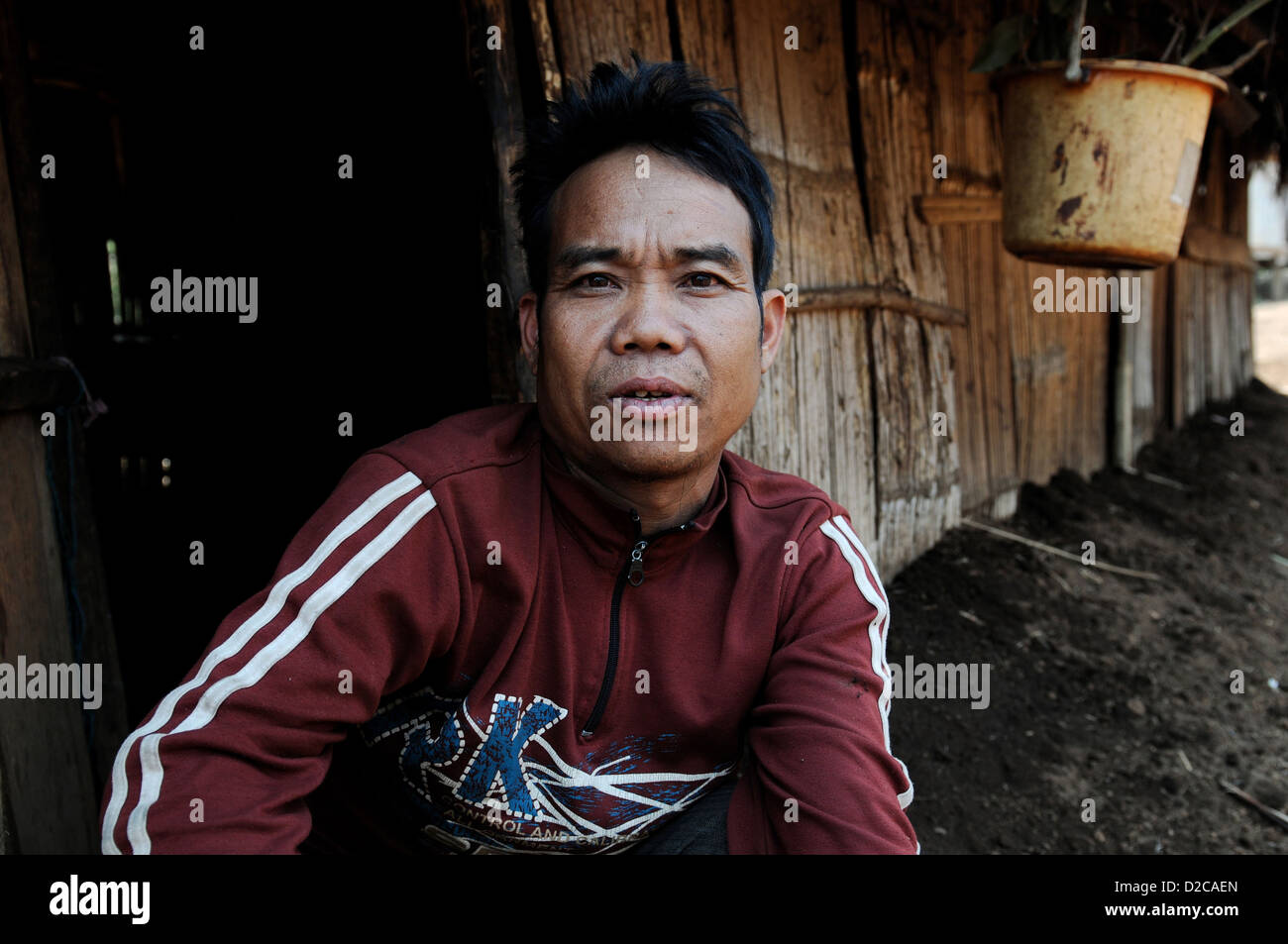 Taunggyi, Myanmar, Burmese refugee sits in front of his hut Stock Photo ...