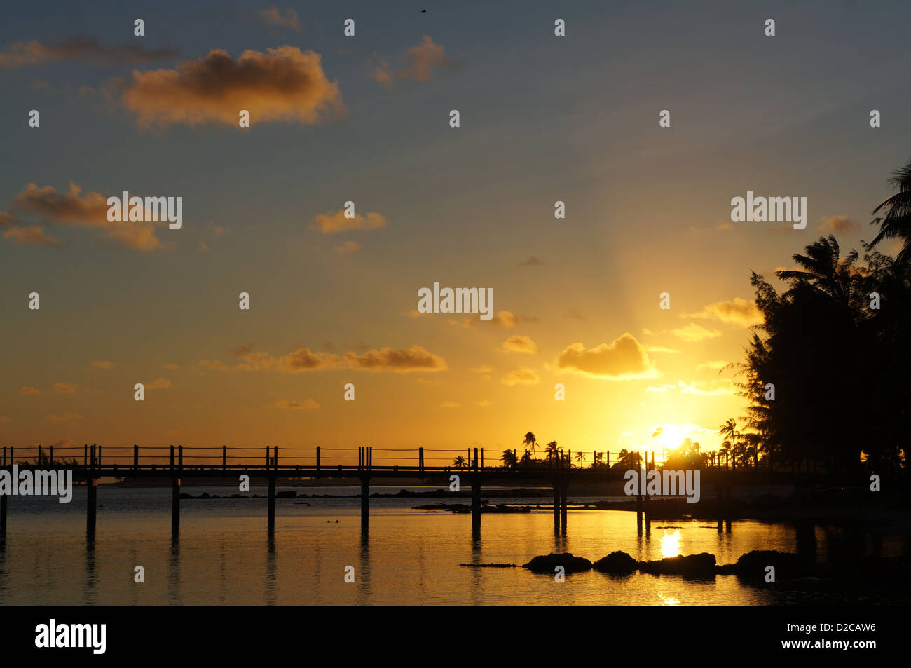 Sunrise over tropical island Stock Photo - Alamy