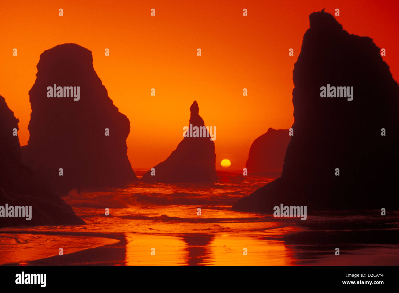 Oregon, Brandon Beach. Sea Stacks Silhouetted By Setting Sun Stock ...
