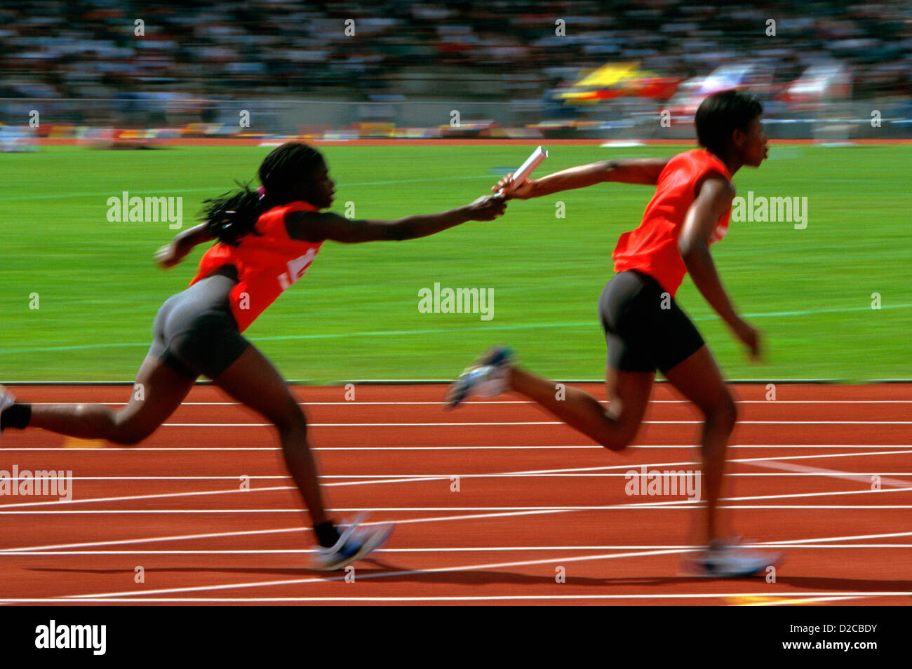 Track Field Runners In A Relay Race Passing Baton Stock Photo Track Field Runners In A Relay Race Passing Baton Stock Photo