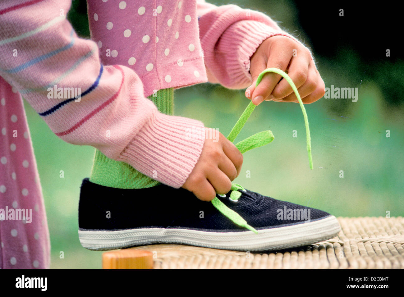 Girl Tying Shoe Stock Photo - Alamy