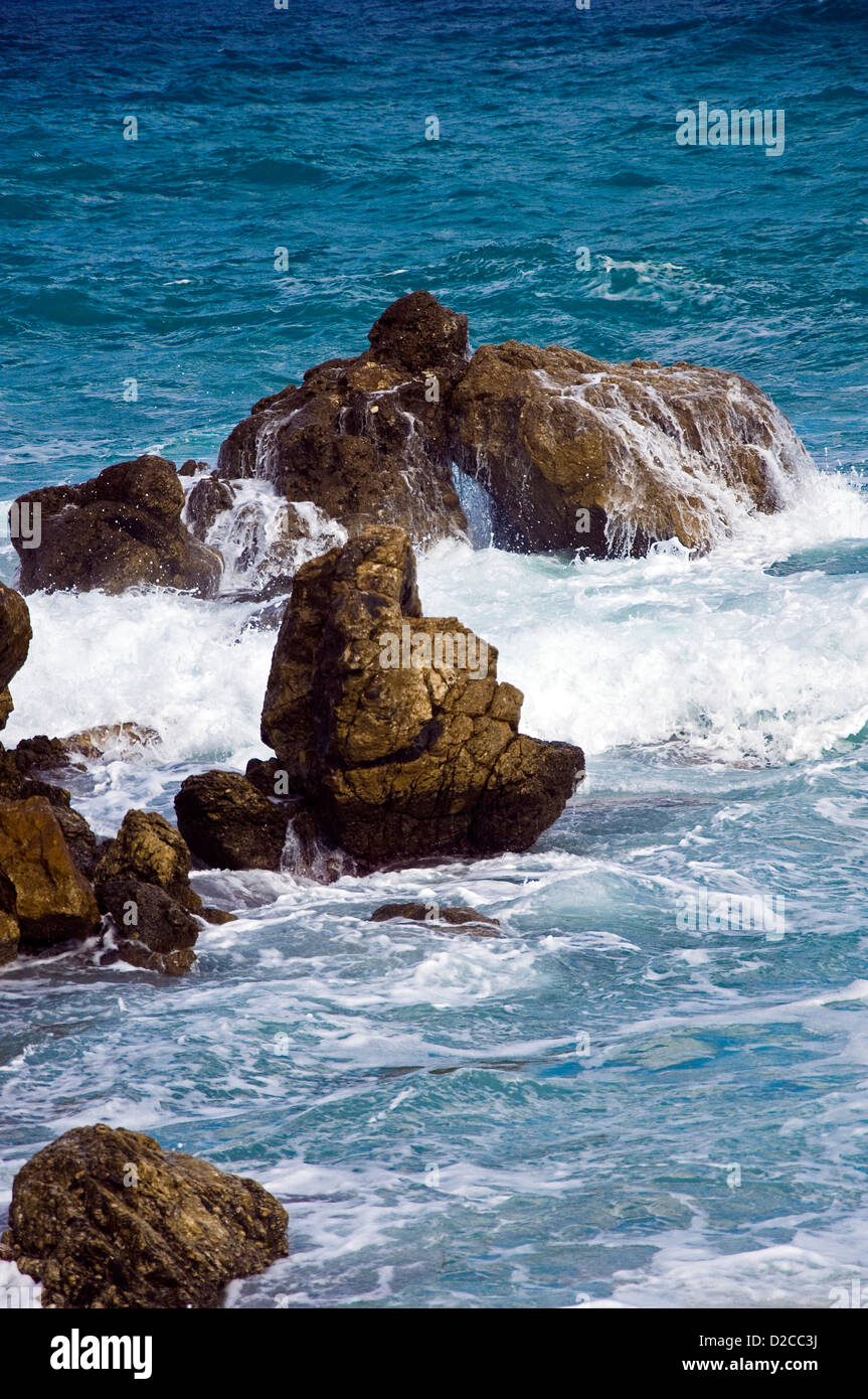 Wave breaking on rocky shore Stock Photo - Alamy