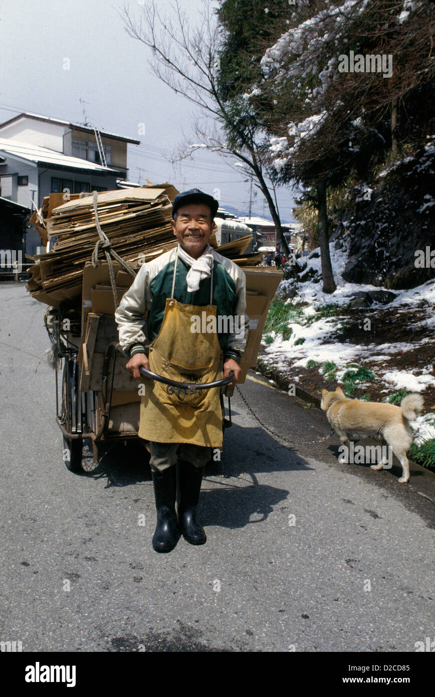 Japan, Takayama. Man Pulling Cart Loaded With Cardboard. Dog On Chain ...