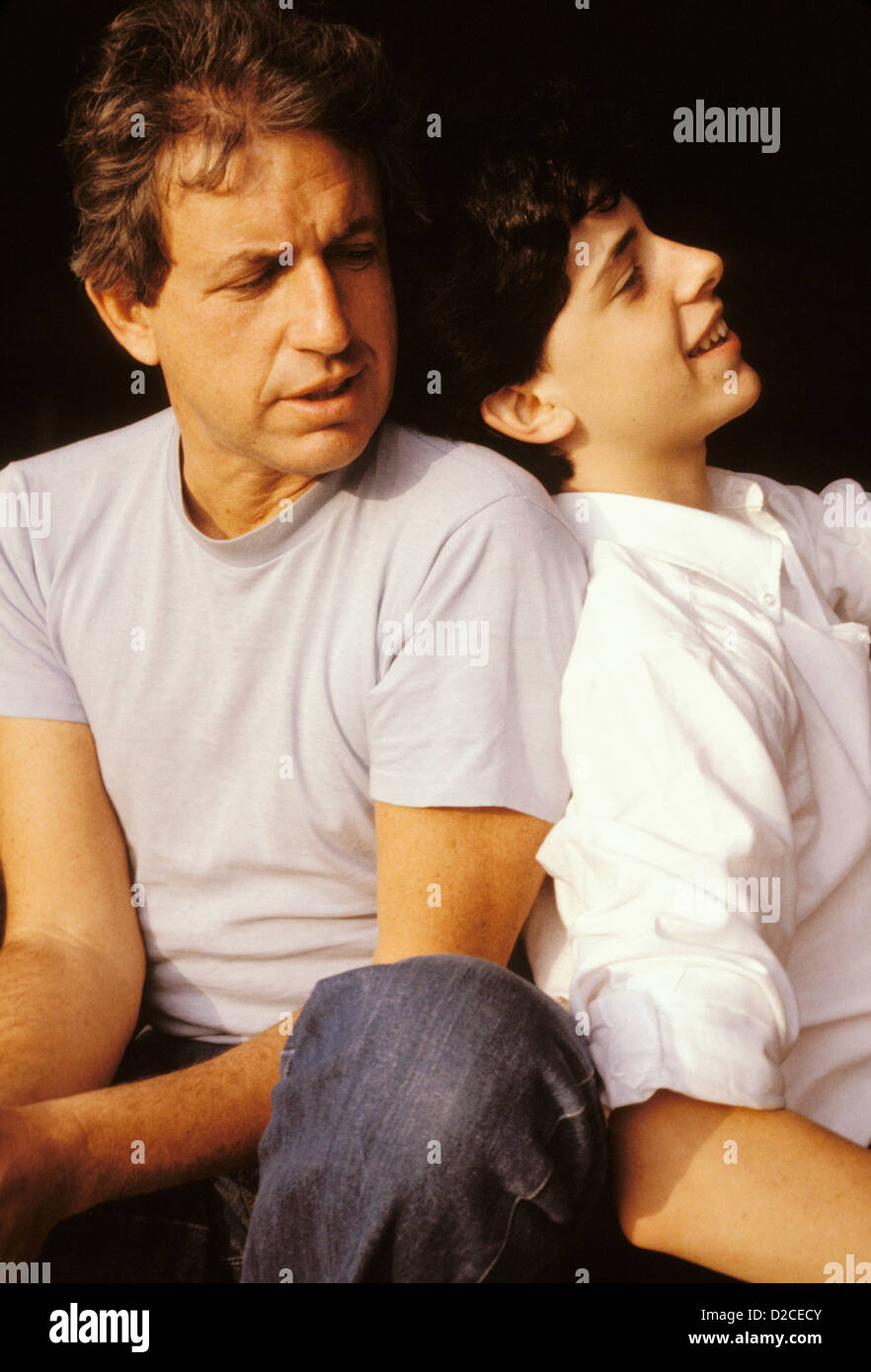 Father & Son Talking. Son Is Leaning On Father Stock Photo - Alamy