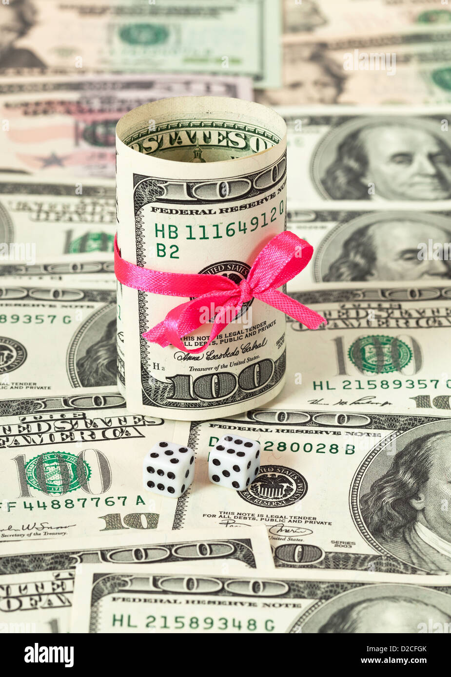 US dollars wrapped by ribbon on money background Stock Photo - Alamy
