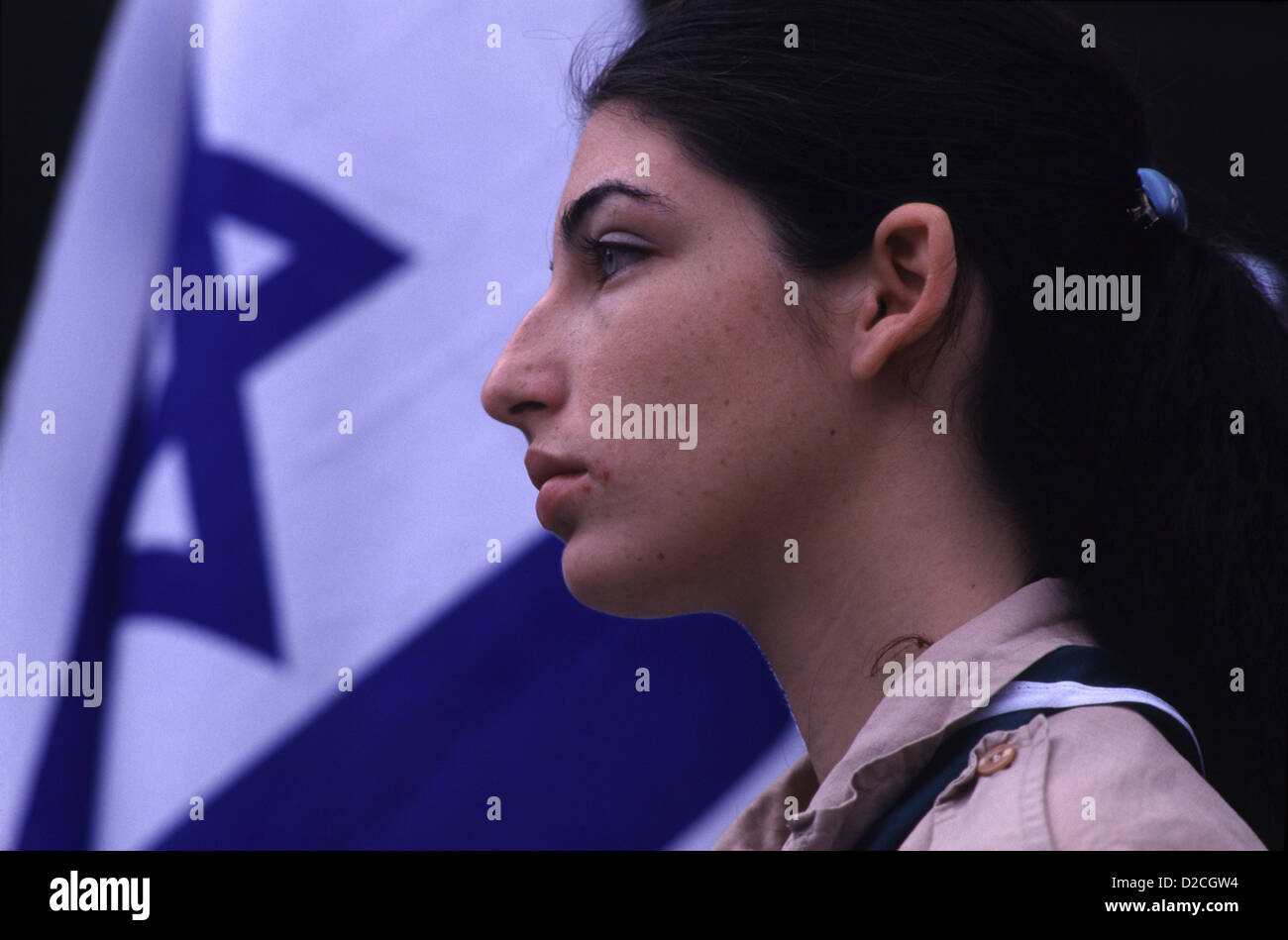 A young member of the Israel Boy and Girl Scouts Federation stand by ...