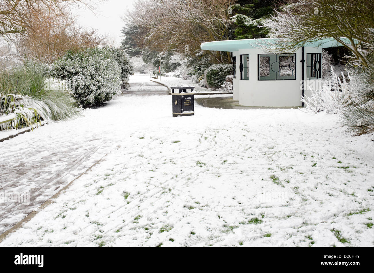 Snowy scene showing snowed over path in a park in the UK Stock Photo ...