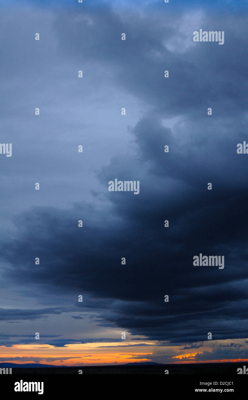 Setting sun and stormy clouds Stock Photo - Alamy