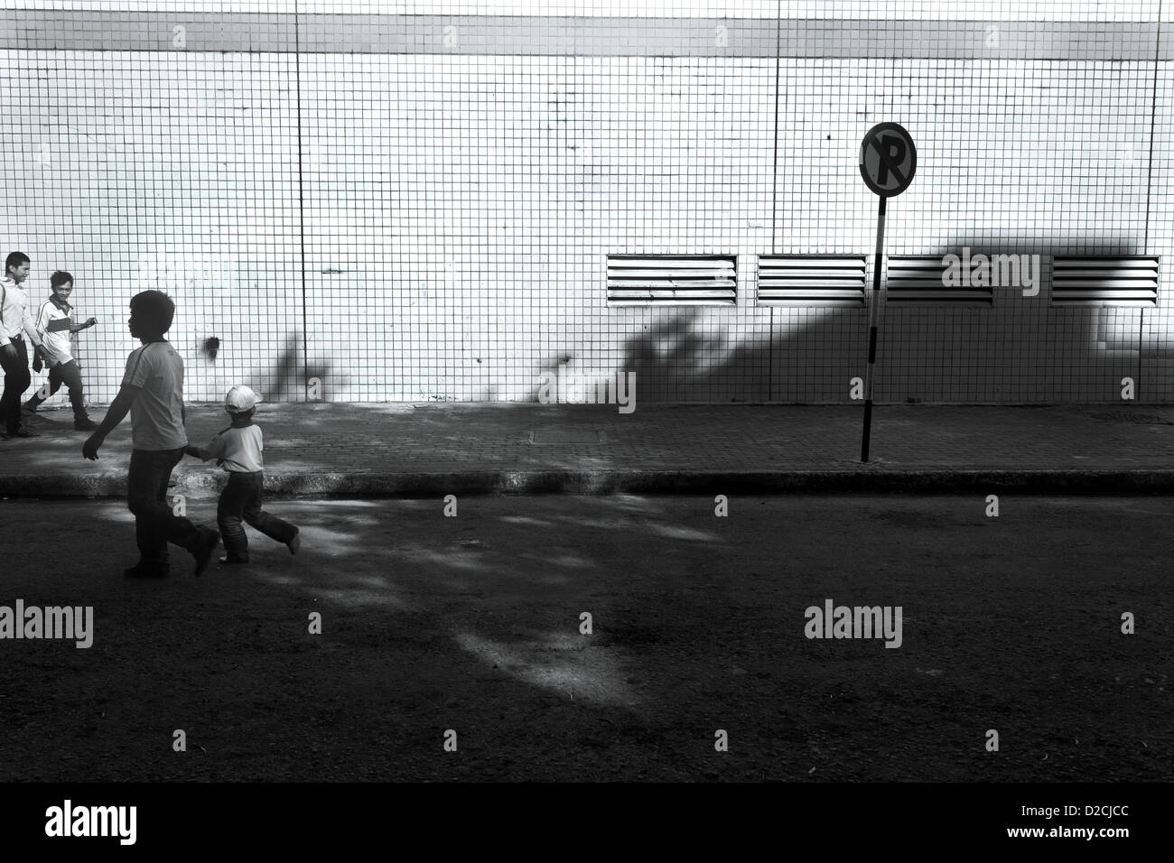 Pedestrians during rush hour walk by a parking garage in downtown Kota ...