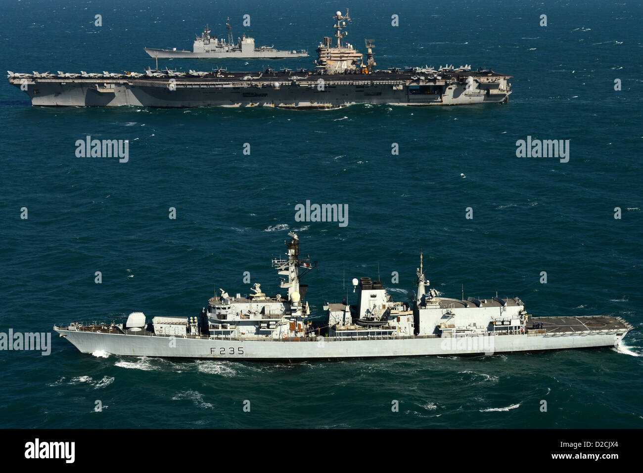 Royal Navy T23 frigate HMS Monmouth (F-235), front, steams alongside ...