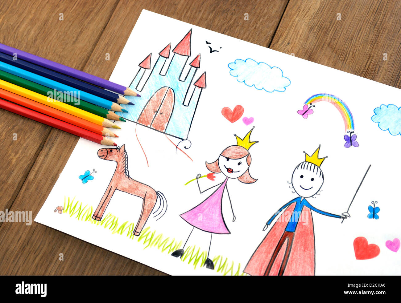 Kids drawing princess and prince picture on the wooden table Stock ...