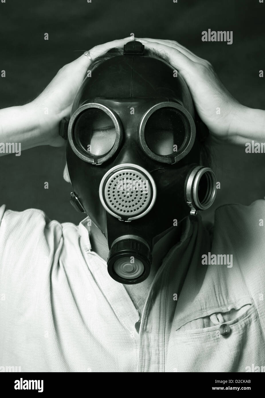 The person in a gas mask holds hands a head Stock Photo - Alamy