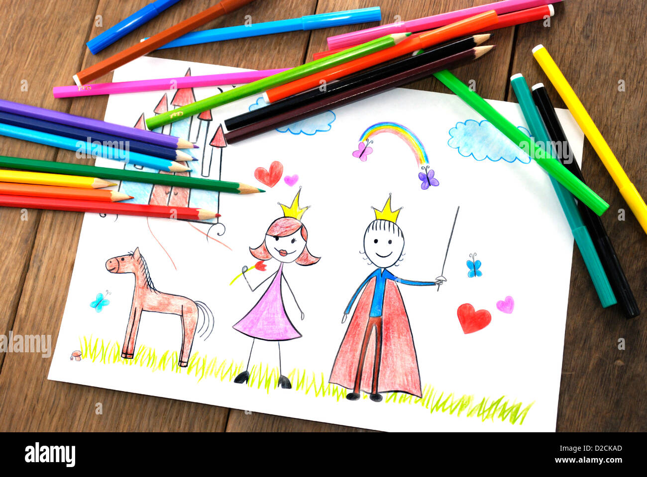 Kids drawing princess and prince picture on the wooden table Stock ...