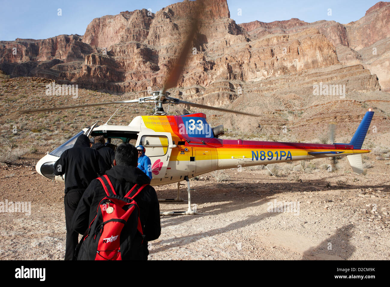 Passengers walking to a helicopter hi-res stock photography and images ...