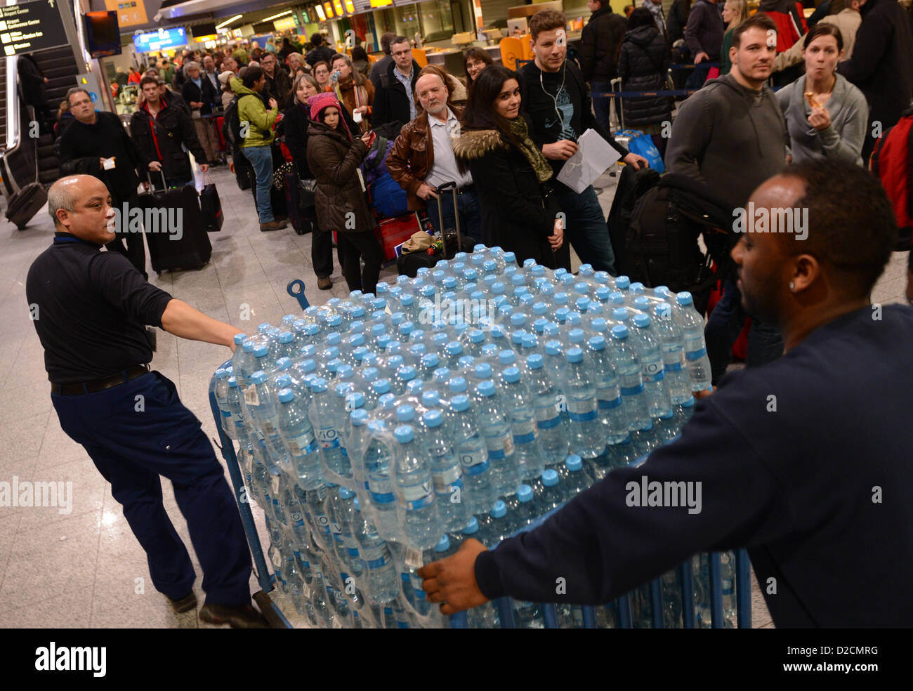 Bottles of water are being distributed to waiting passengers in ...