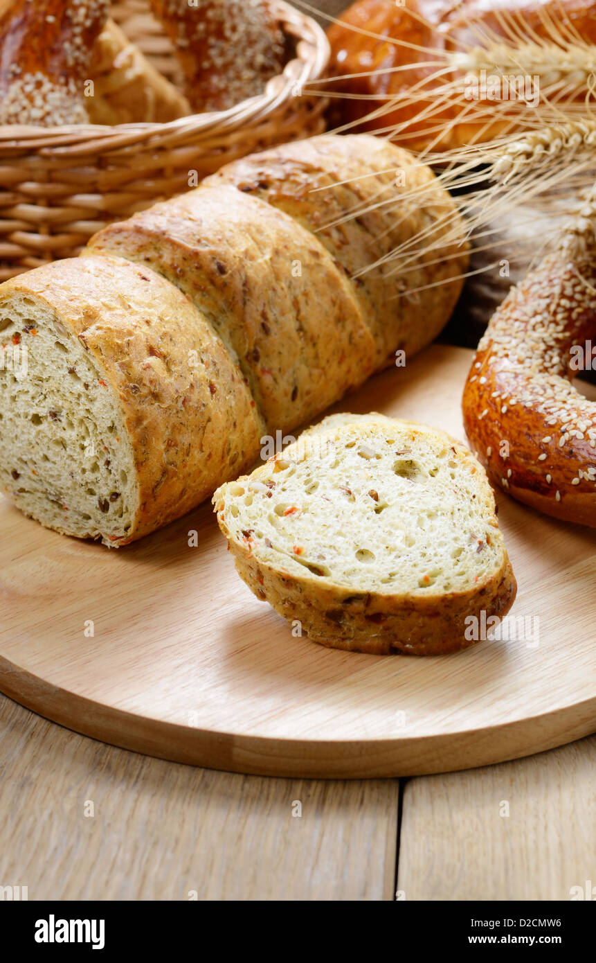 Group of bread loaves, buns, rolls on the wooden table Stock Photo - Alamy