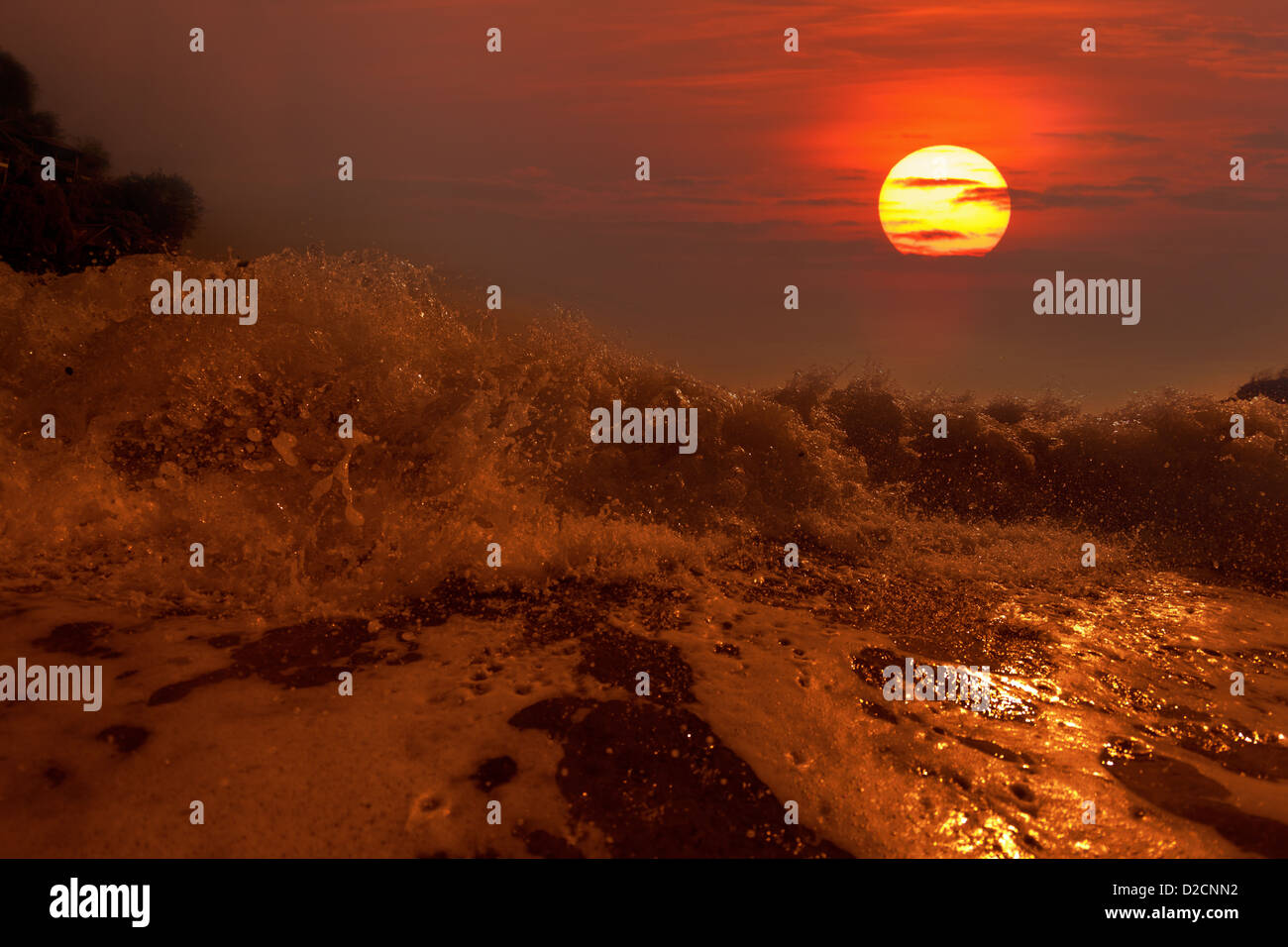 Big wave front with bubbles and splashes at sunset Stock Photo - Alamy