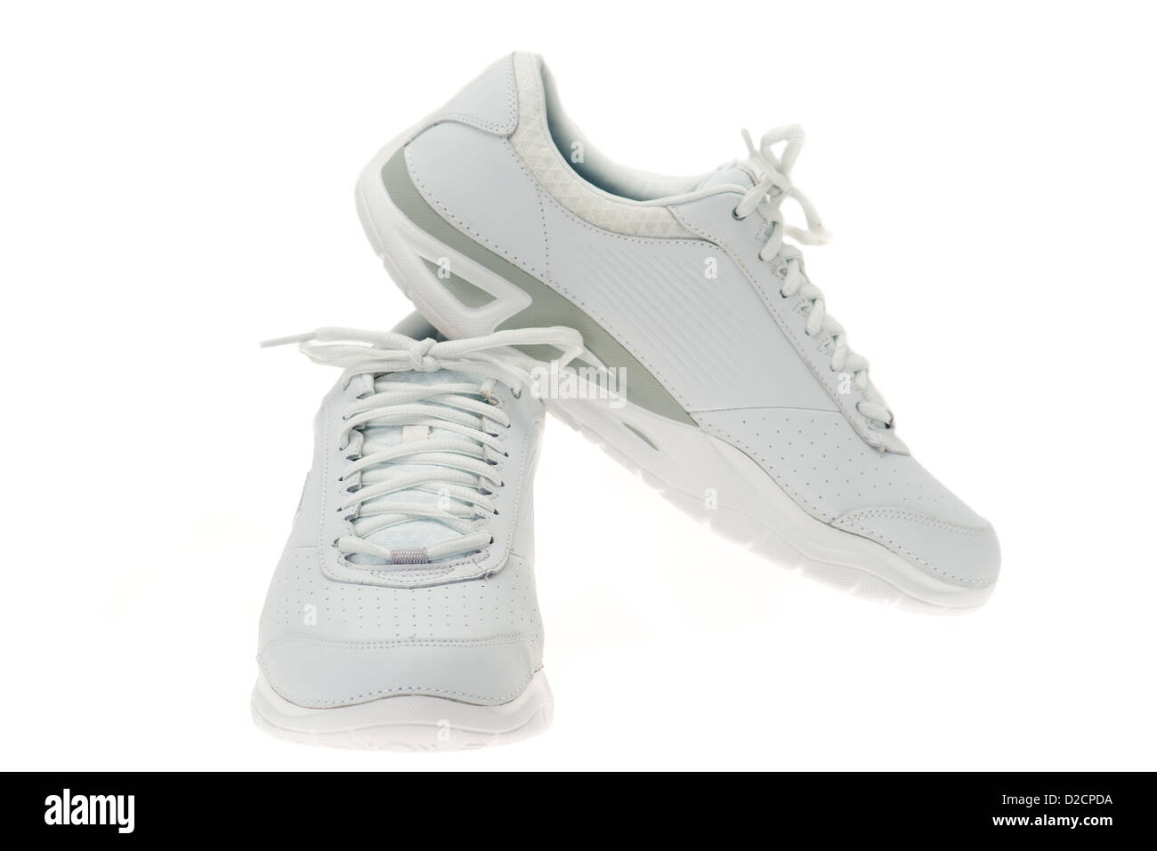 A pair of new white sports shoes - a brightly lit studio shot with a ...