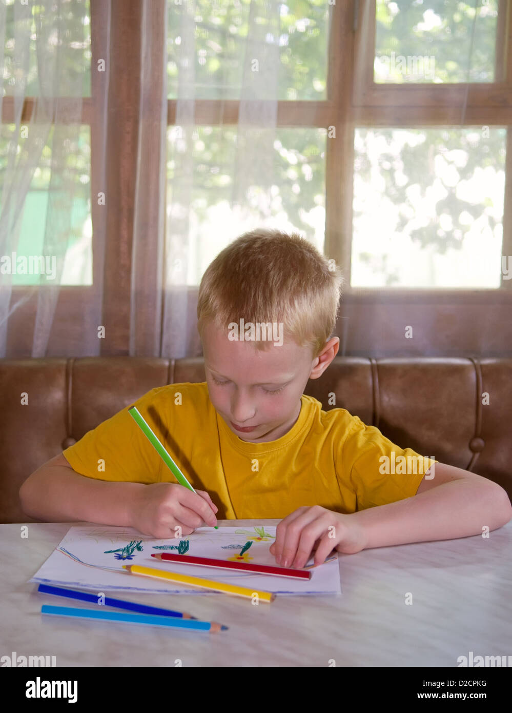 young boy drawing positive picture with pencils Stock Photo - Alamy