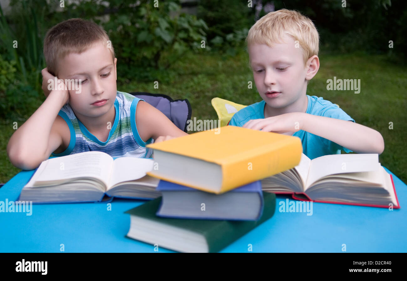 Two boys reading two books school hi-res stock photography and images ...