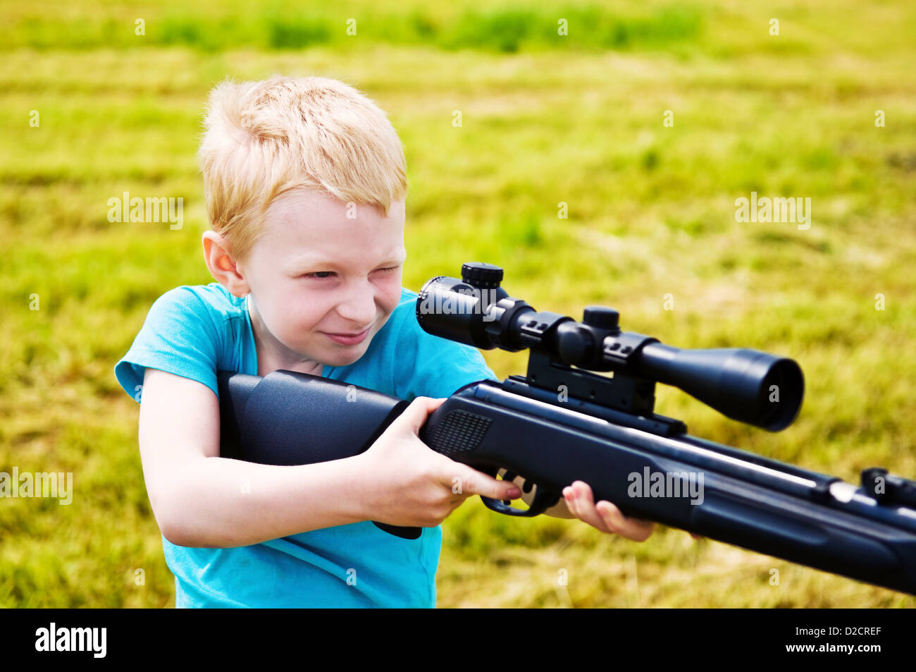 young boy aiming, looking into the scope of his rifle Stock Photo - Alamy