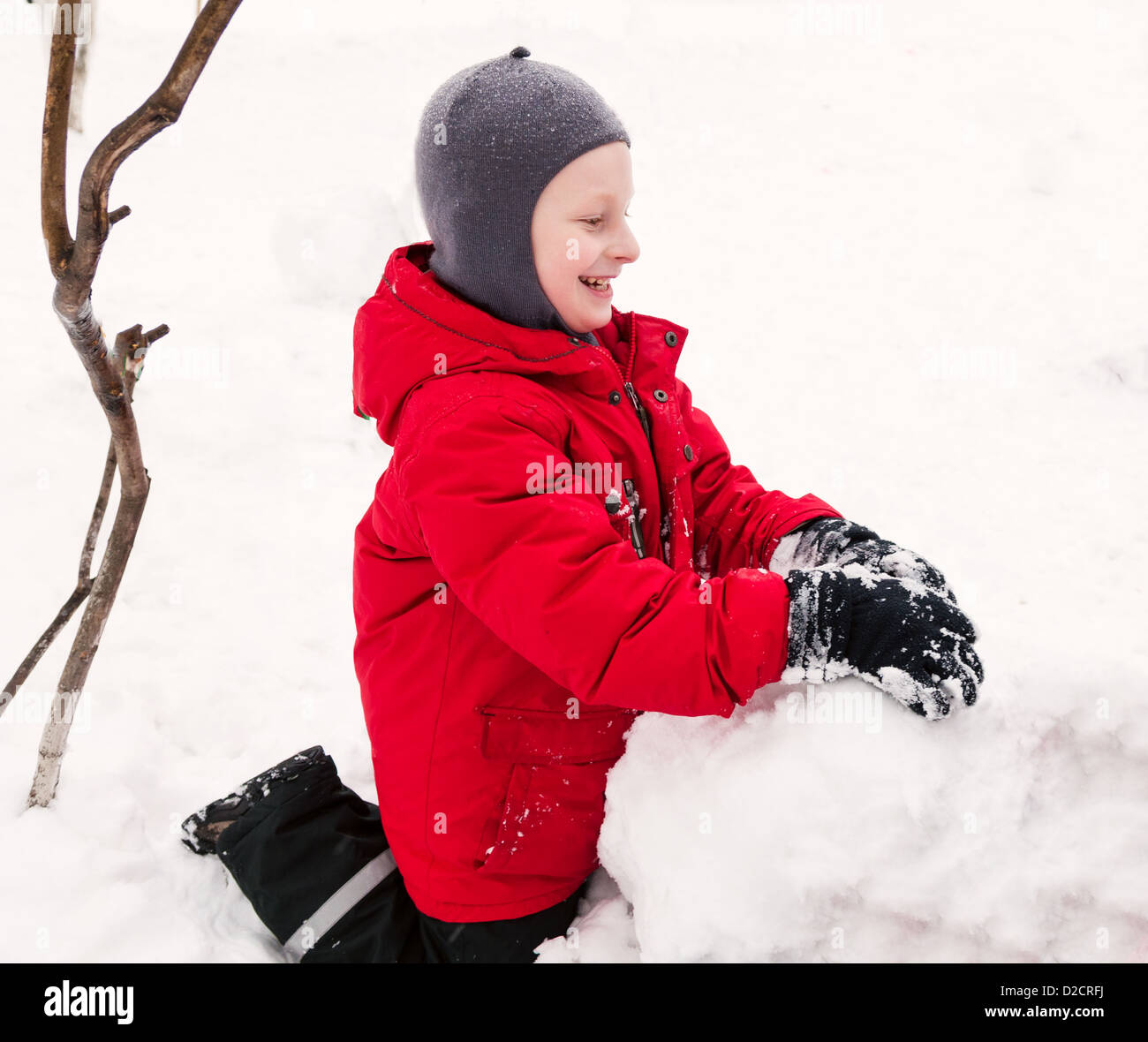 Boy making snowball smiling hi-res stock photography and images - Alamy