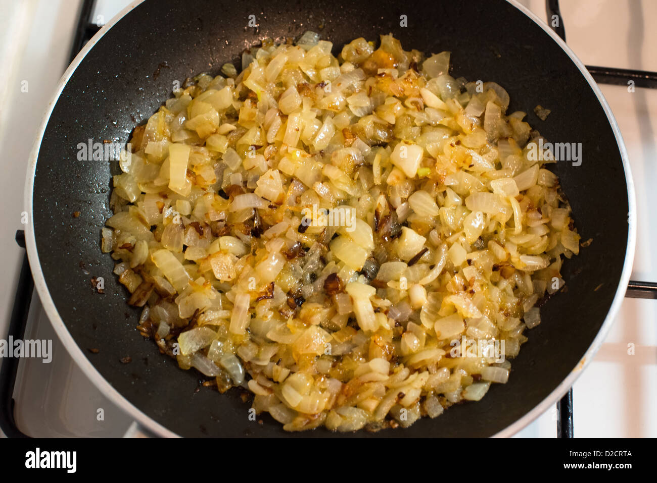 Onion frying in a pan with butter Stock Photo - Alamy