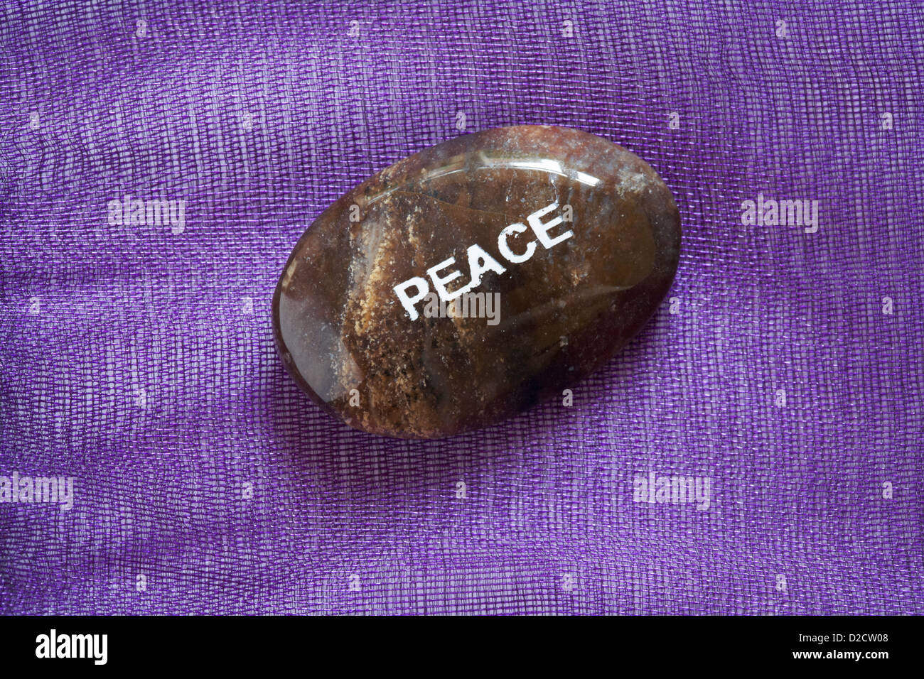 Fair Trade sentiment pebbles - Peace pebble isolated on purple ...