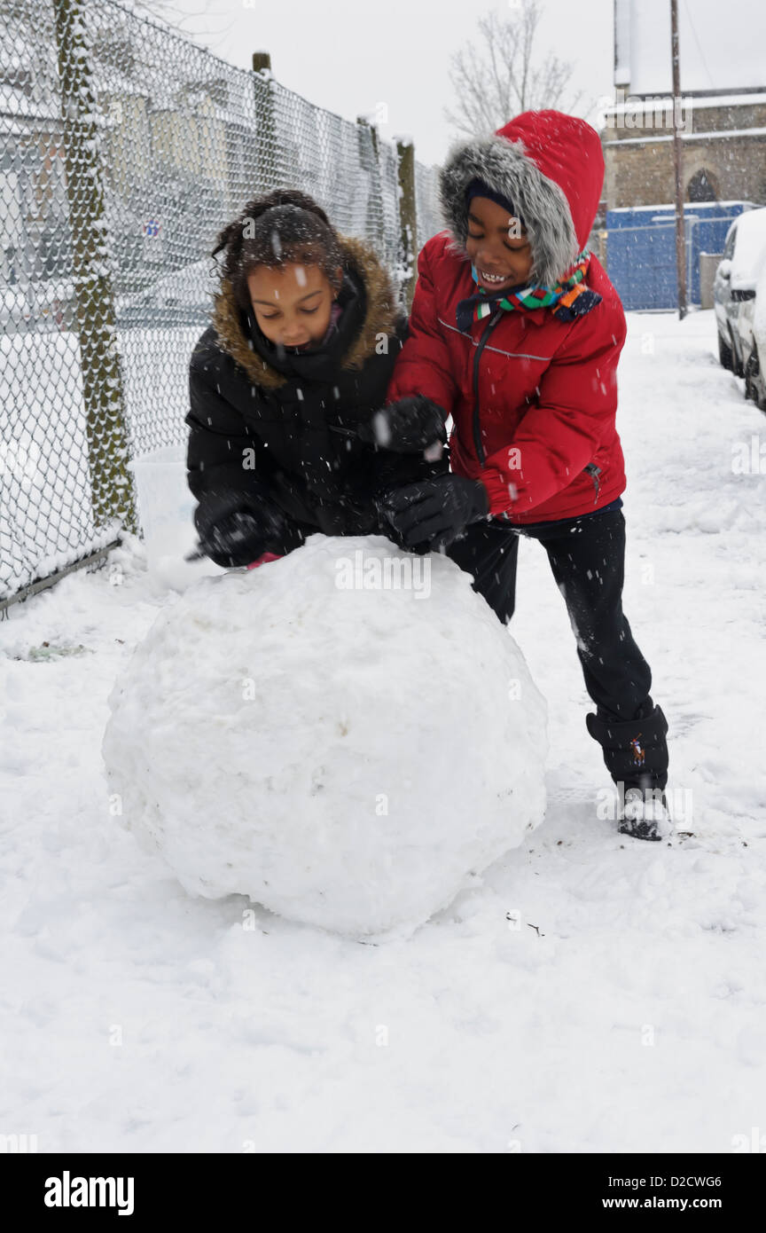 Children rolling a big snowball, United Kingdom Stock Photo - Alamy