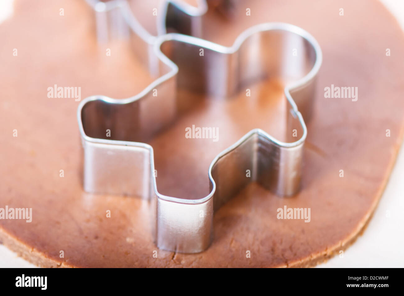 Pastry cutter in the shape of gingerbread man on dough, defocused Stock ...