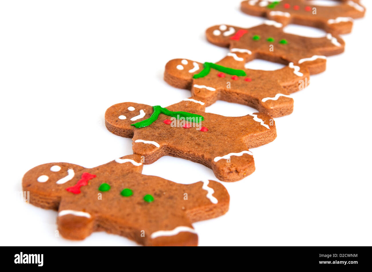Gingerbread men in a row on white background, focus on second ...