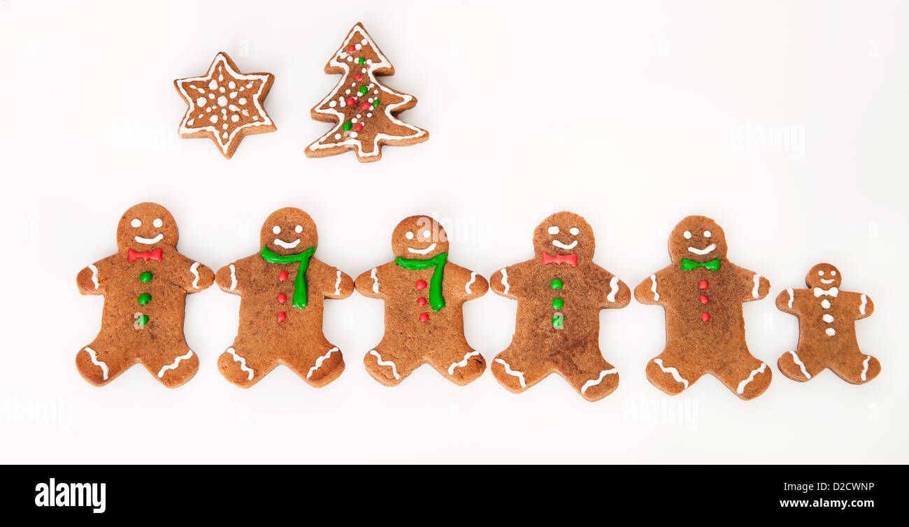 Big and small Gingerbread men in a row on white background Stock Photo ...