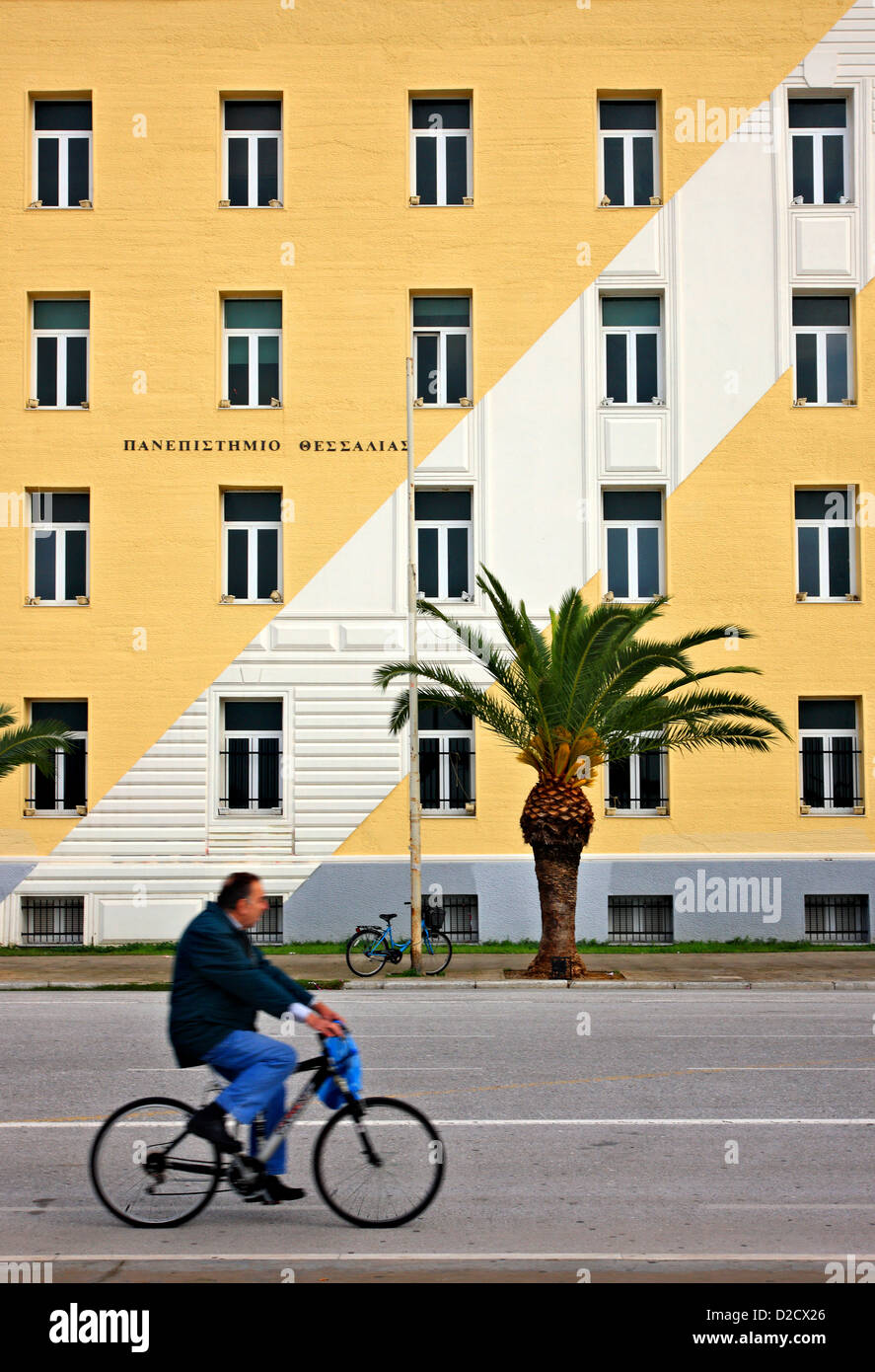 Cyclist passing in front of the building of the University of Thessaly ...