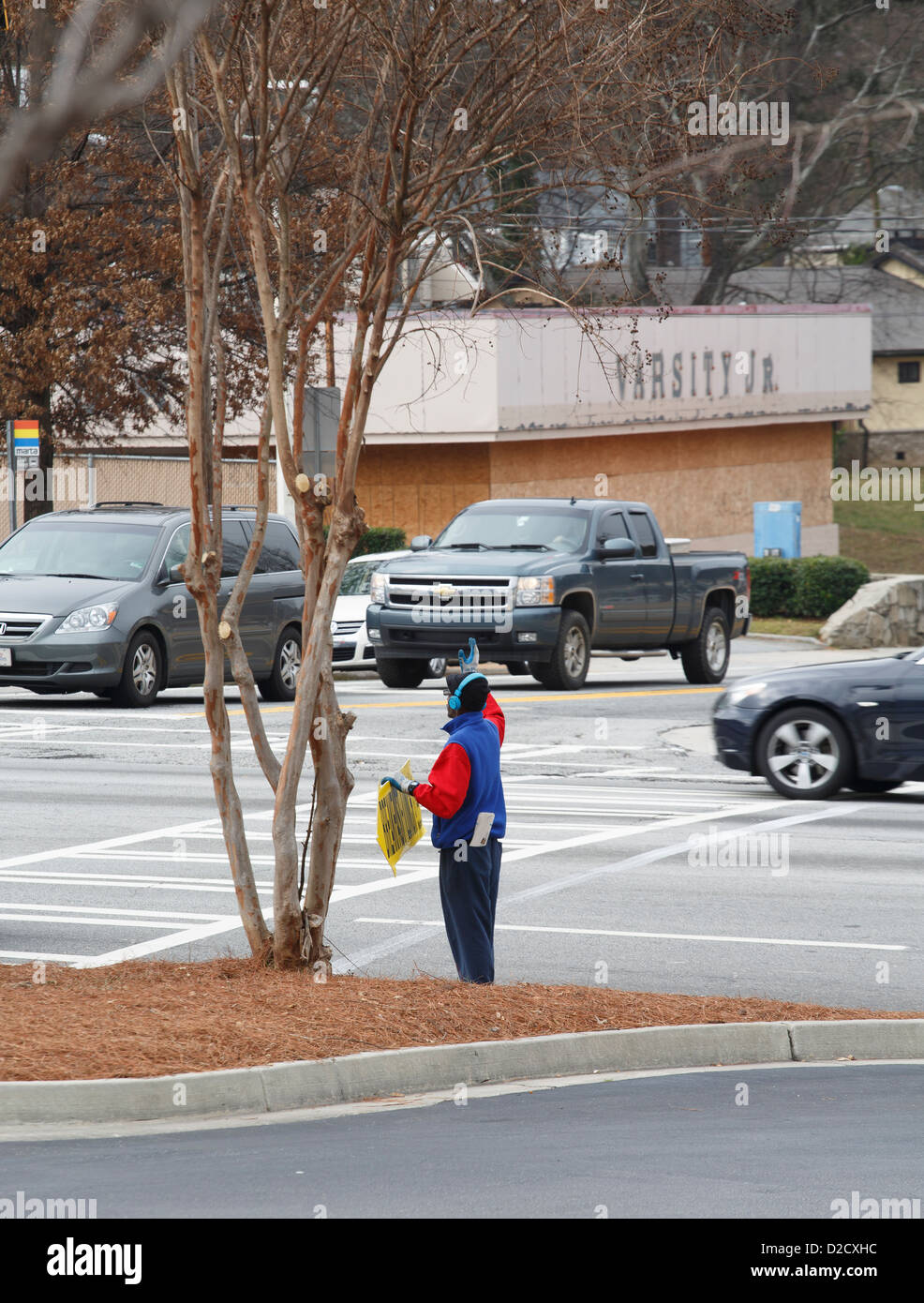 A man working a street with a sign Stock Photo - Alamy