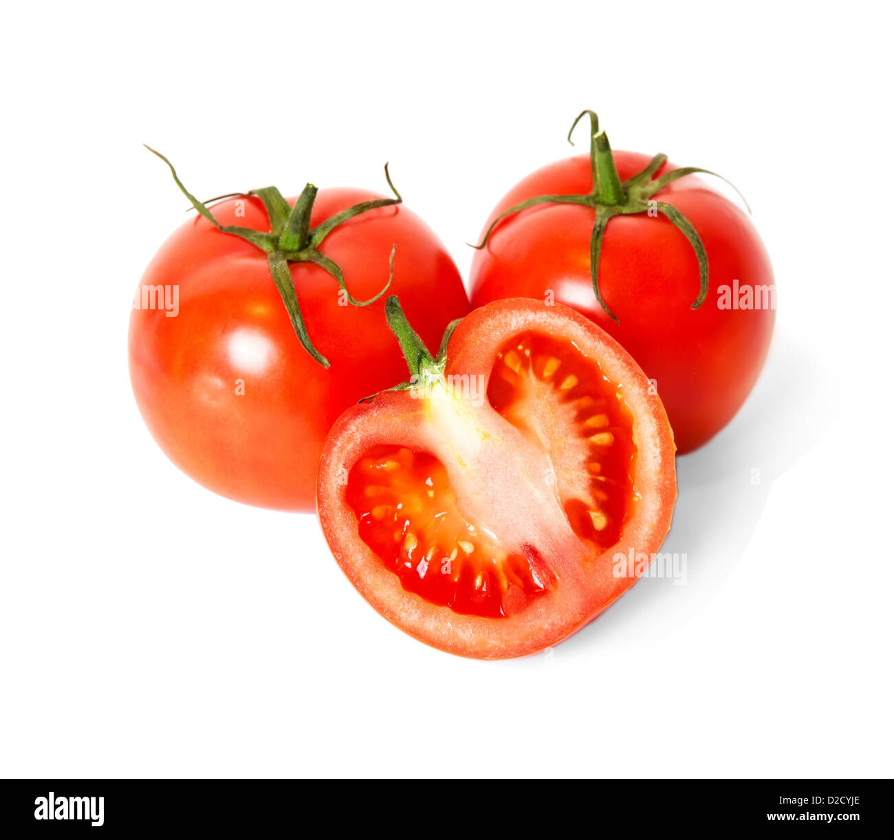 Two whole tomatoes and one half. Isolated on white background Stock ...