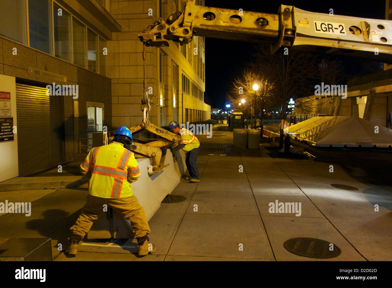 January 20, 2013, Washington DC. Workers move a ten foot Jersey Barrier ...