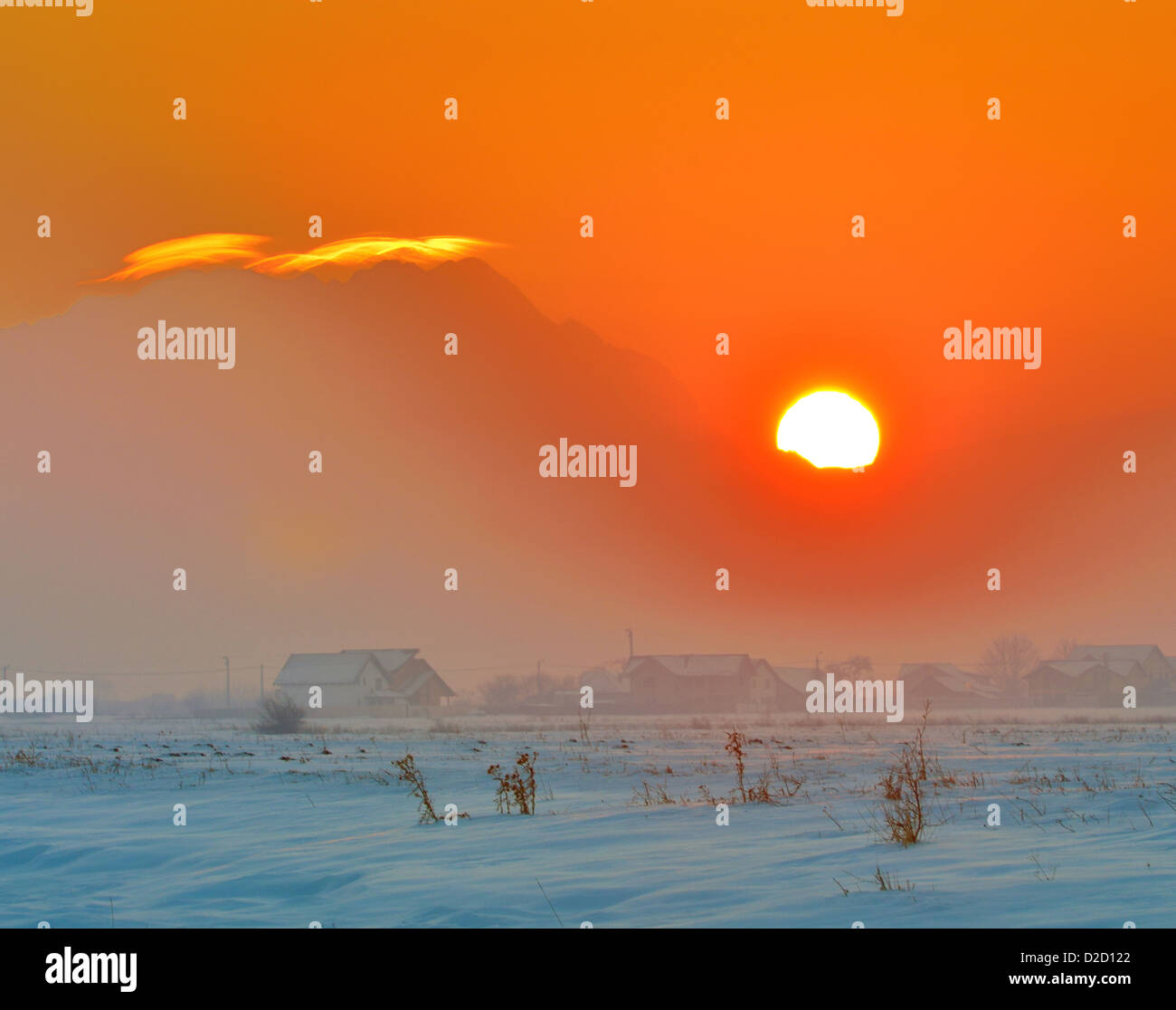 sunset over village Stock Photo - Alamy