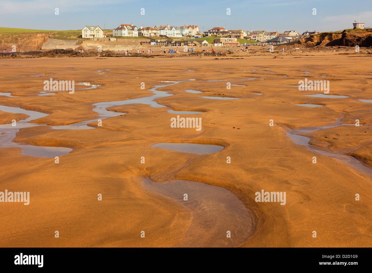 View to seafront from across Crooklets sandy beach with tidal pools at ...