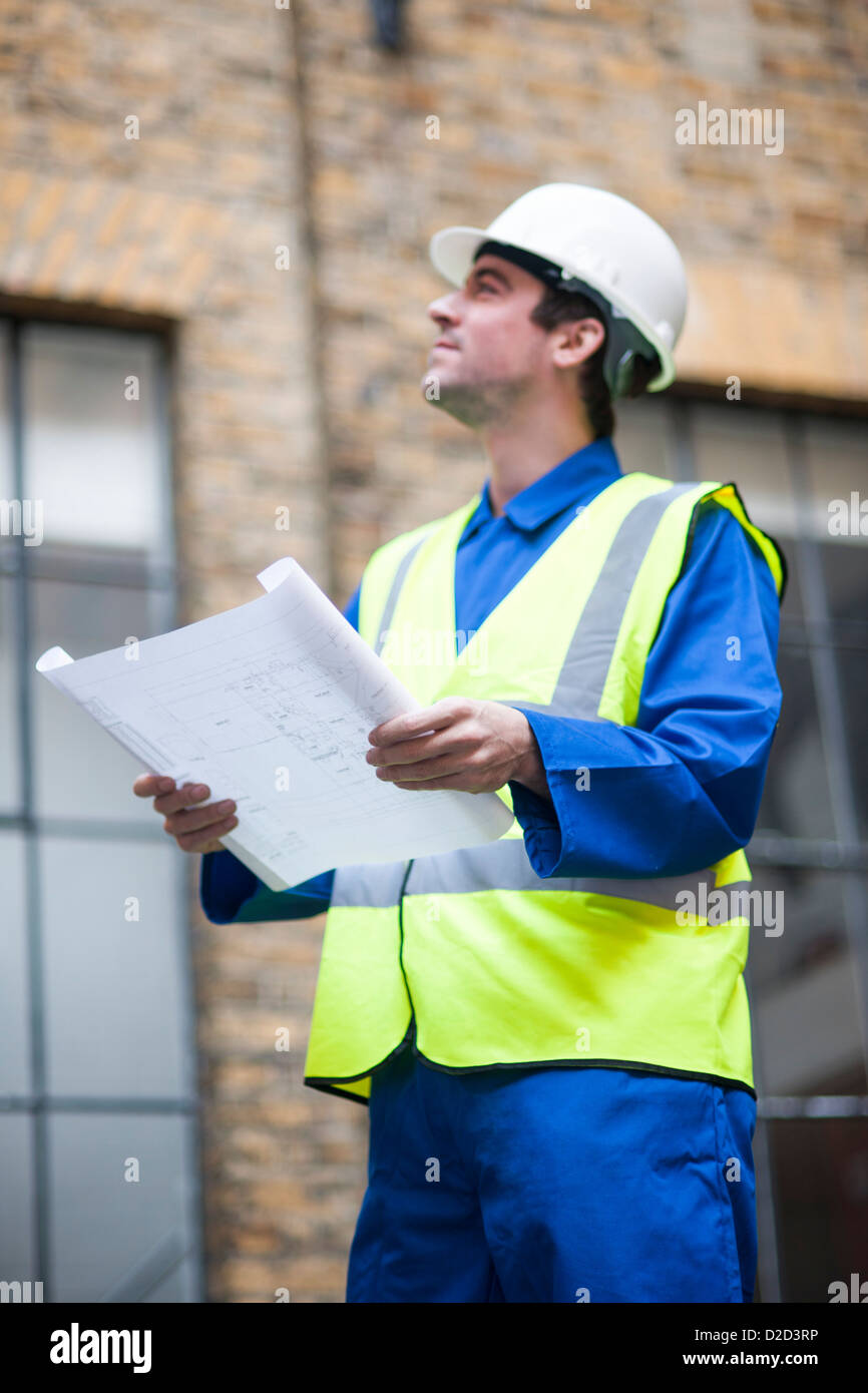 MODEL RELEASED Construction worker wearing a hard hat and a high ...