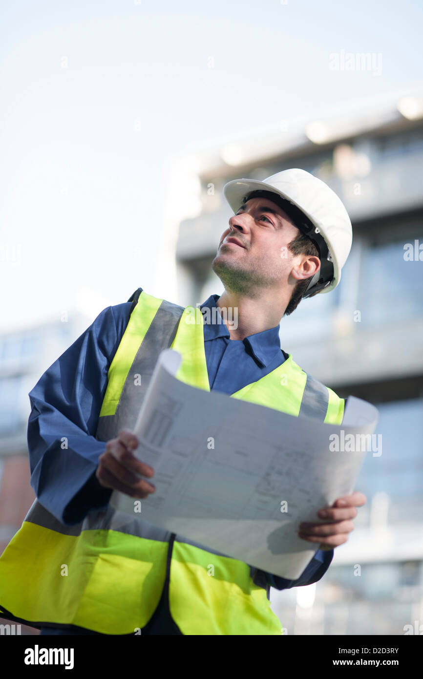 MODEL RELEASED Construction worker wearing a hard hat and a high ...