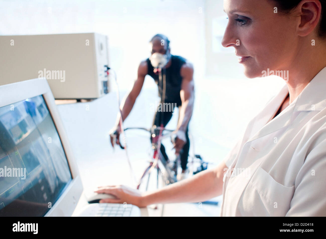 MODEL RELEASED Performance testing Athlete riding an exercise bike ...