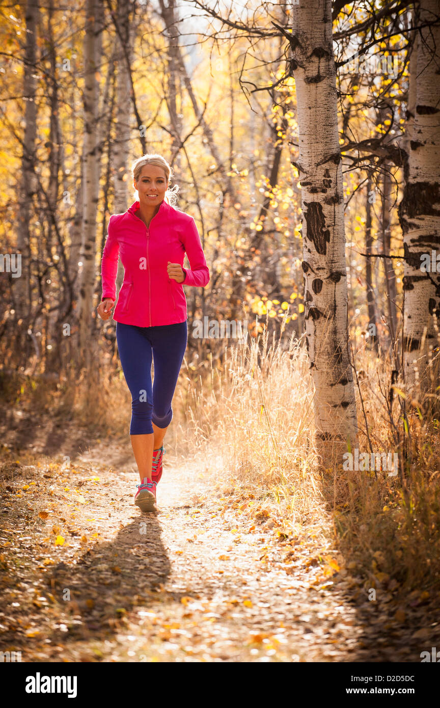 Woman jogging on dirt path Stock Photo - Alamy
