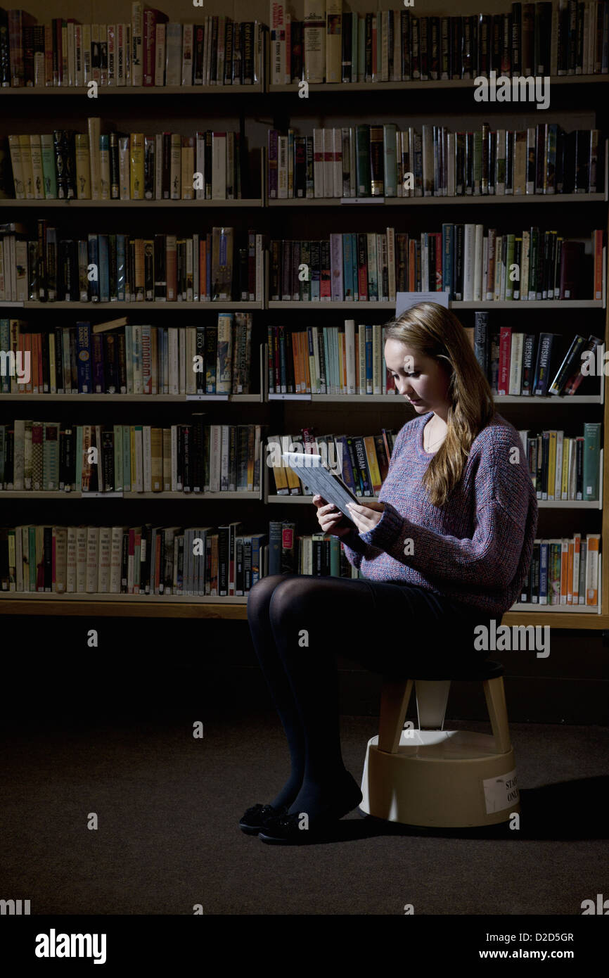 Student using tablet computer in library Stock Photo - Alamy