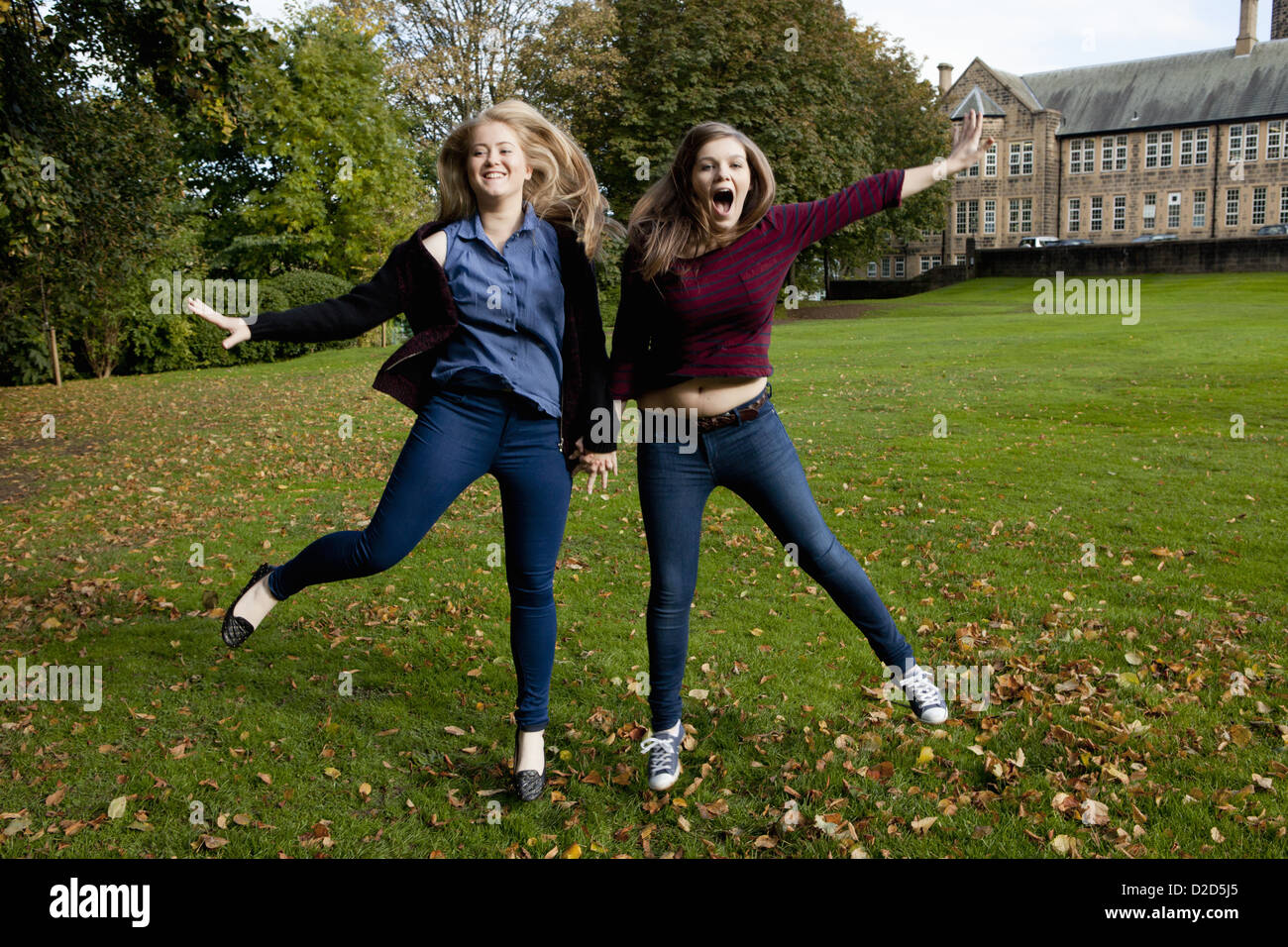 Smiling students playing on campus Stock Photo - Alamy
