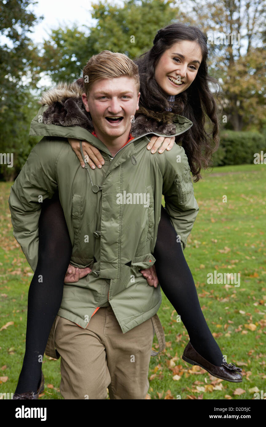 Man carrying girlfriend in park Stock Photo - Alamy