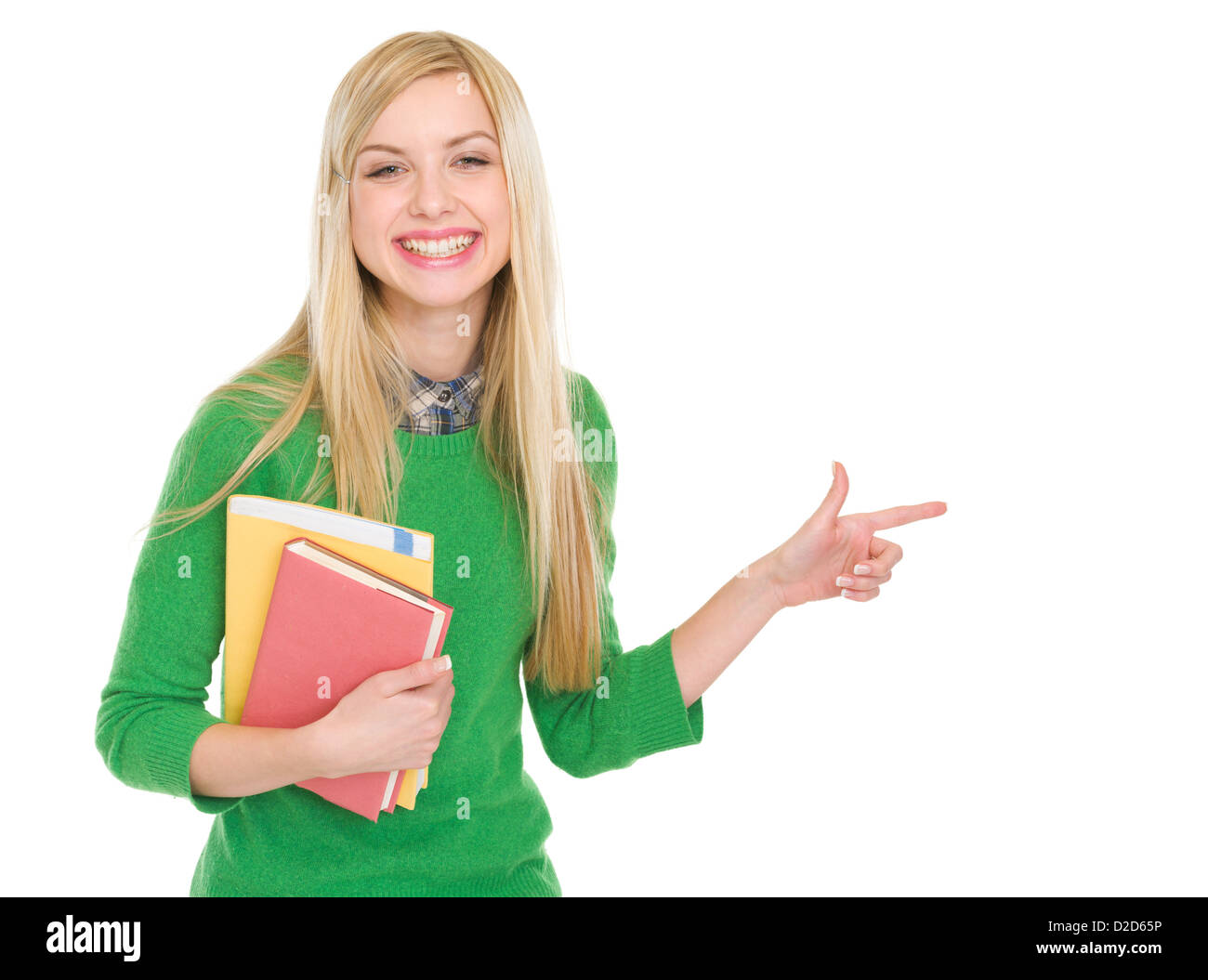 Smiling student girl with books pointing on copy space Stock Photo - Alamy