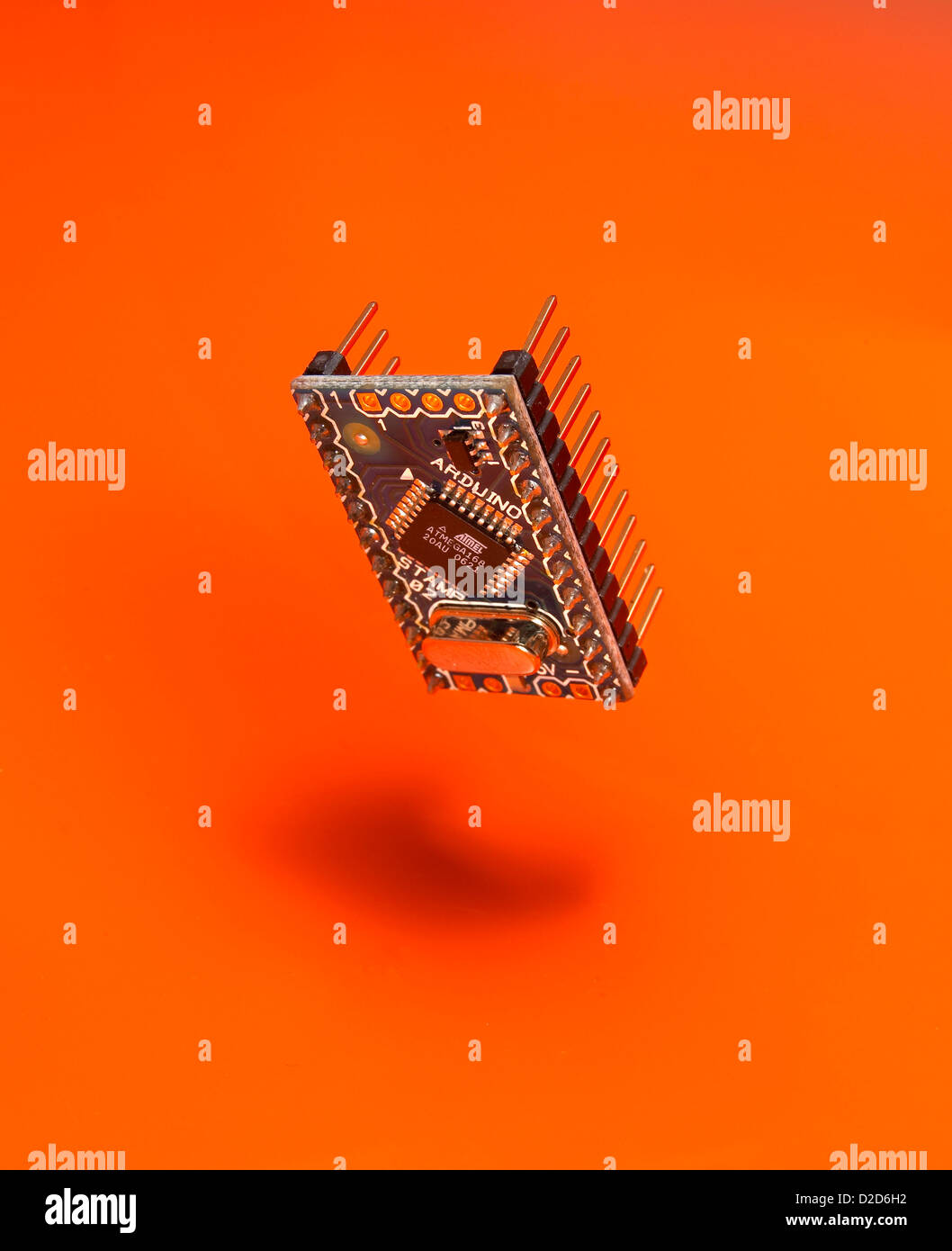 Micro chip suspended in air cut out orange background Stock Photo - Alamy